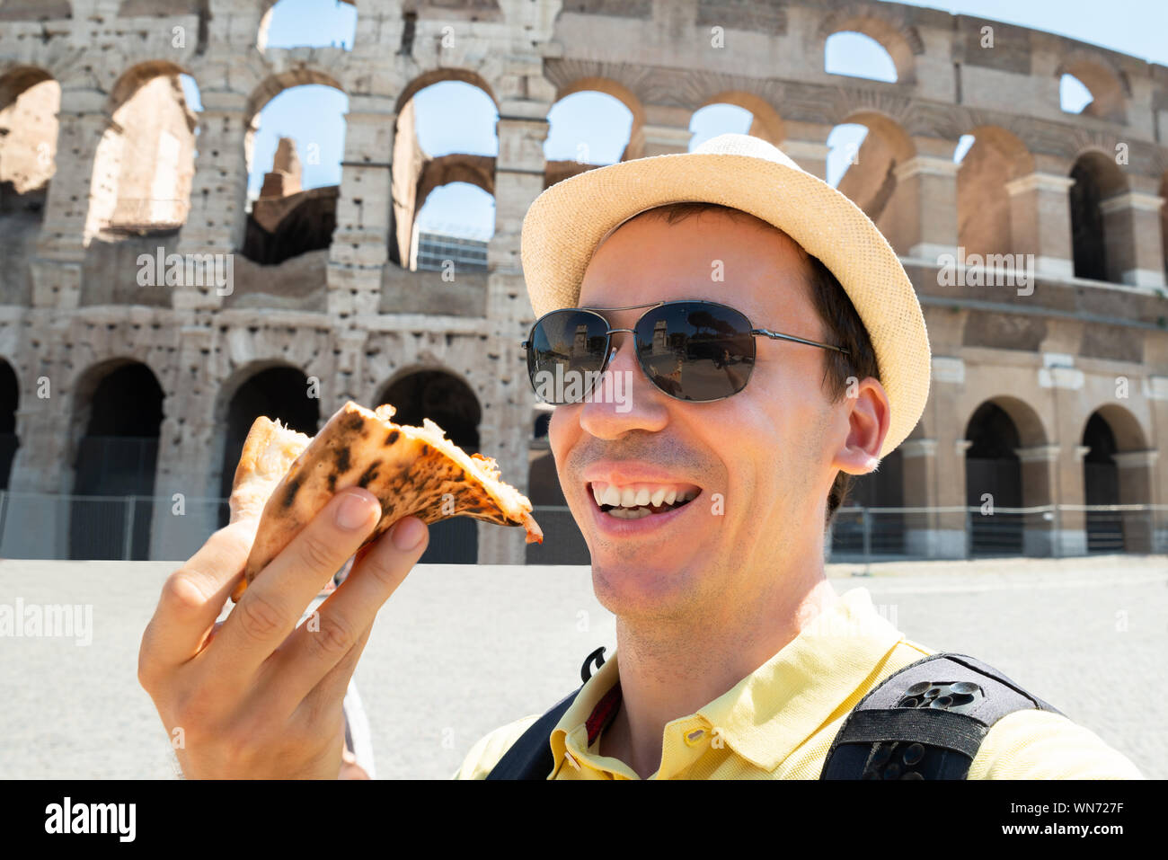 Man Eating Italian Pizza Near Colosseum, Rome Stock Photo - Alamy