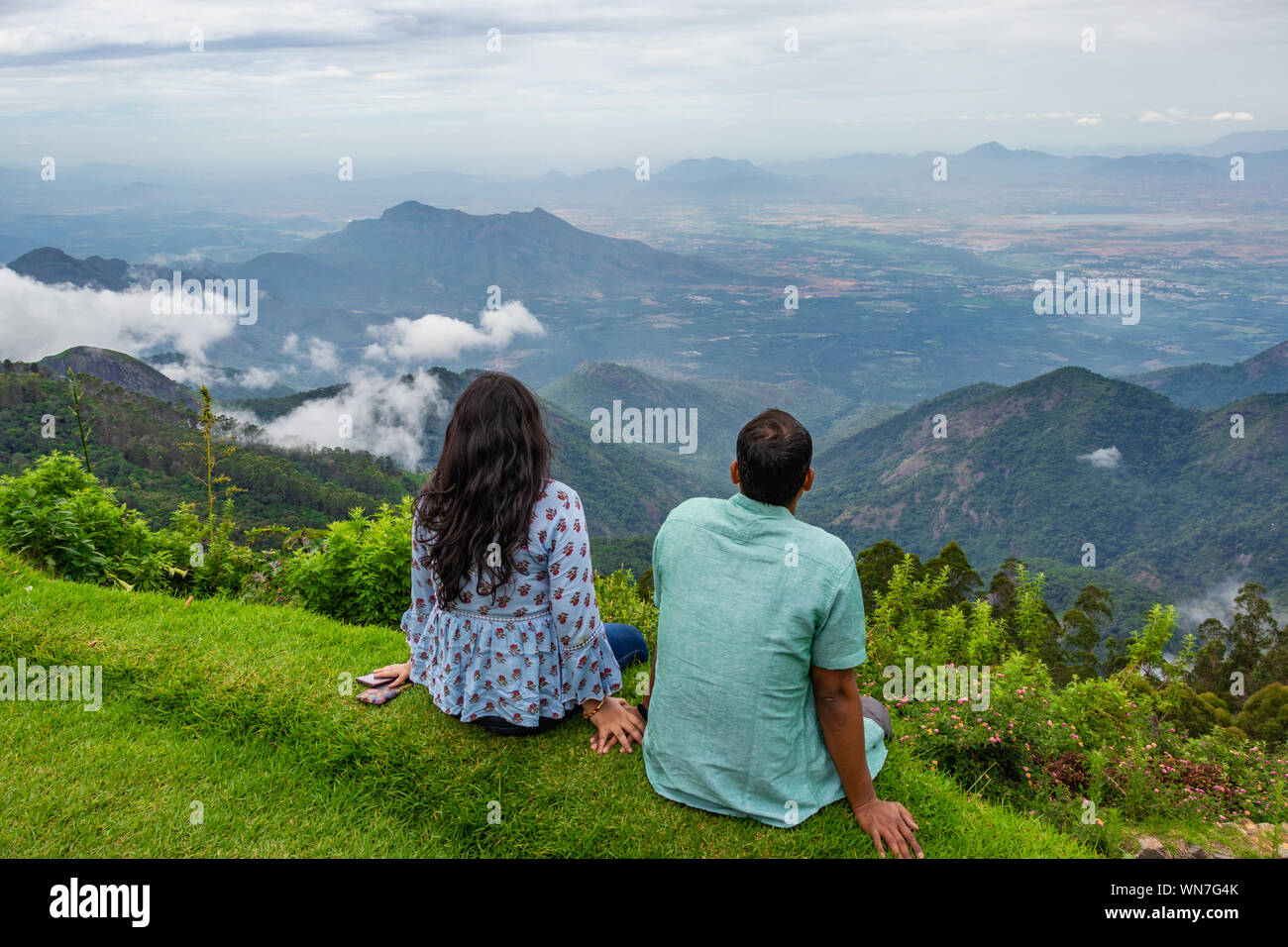 Couple Isolated soaking up natural beauty from hill top image is ...