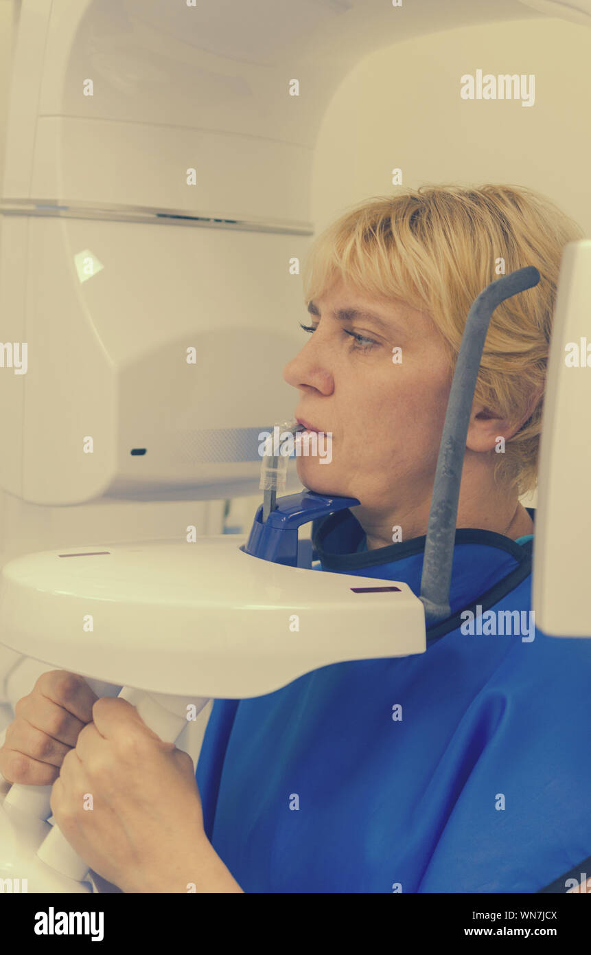 A 45 50-year-old woman undergoes an X-ray examination of the upper and ...