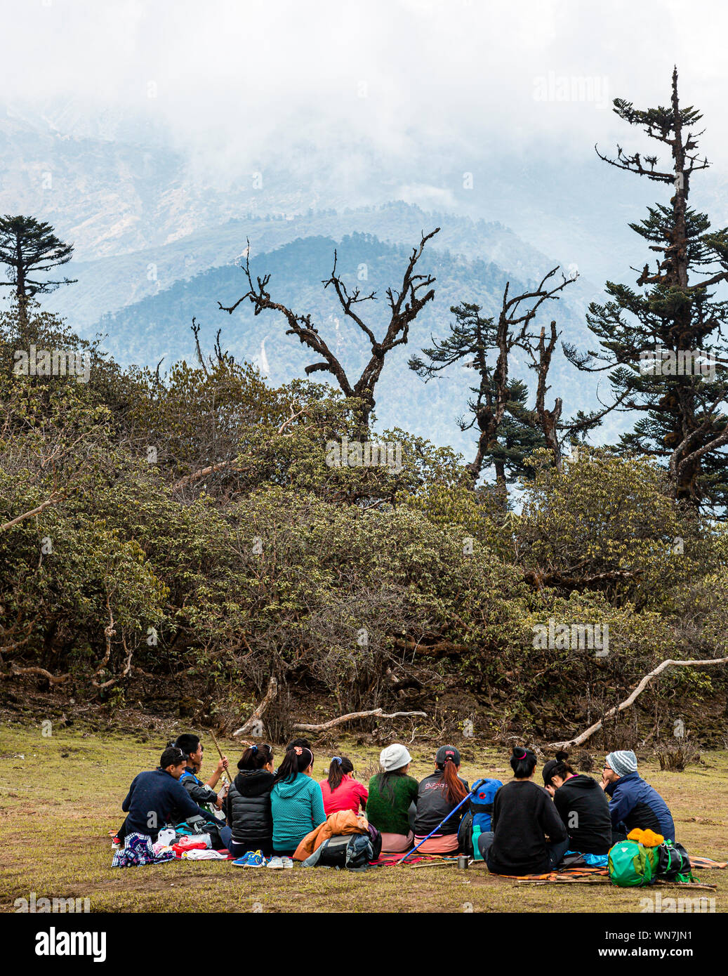 Group of trekkers resting in a meadow on the Gochela trek in the ...