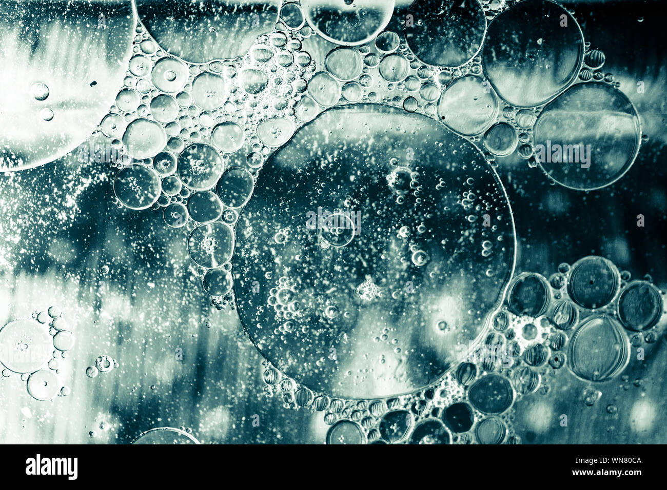 Oil bubbles inside water base form patterns Stock Photo - Alamy