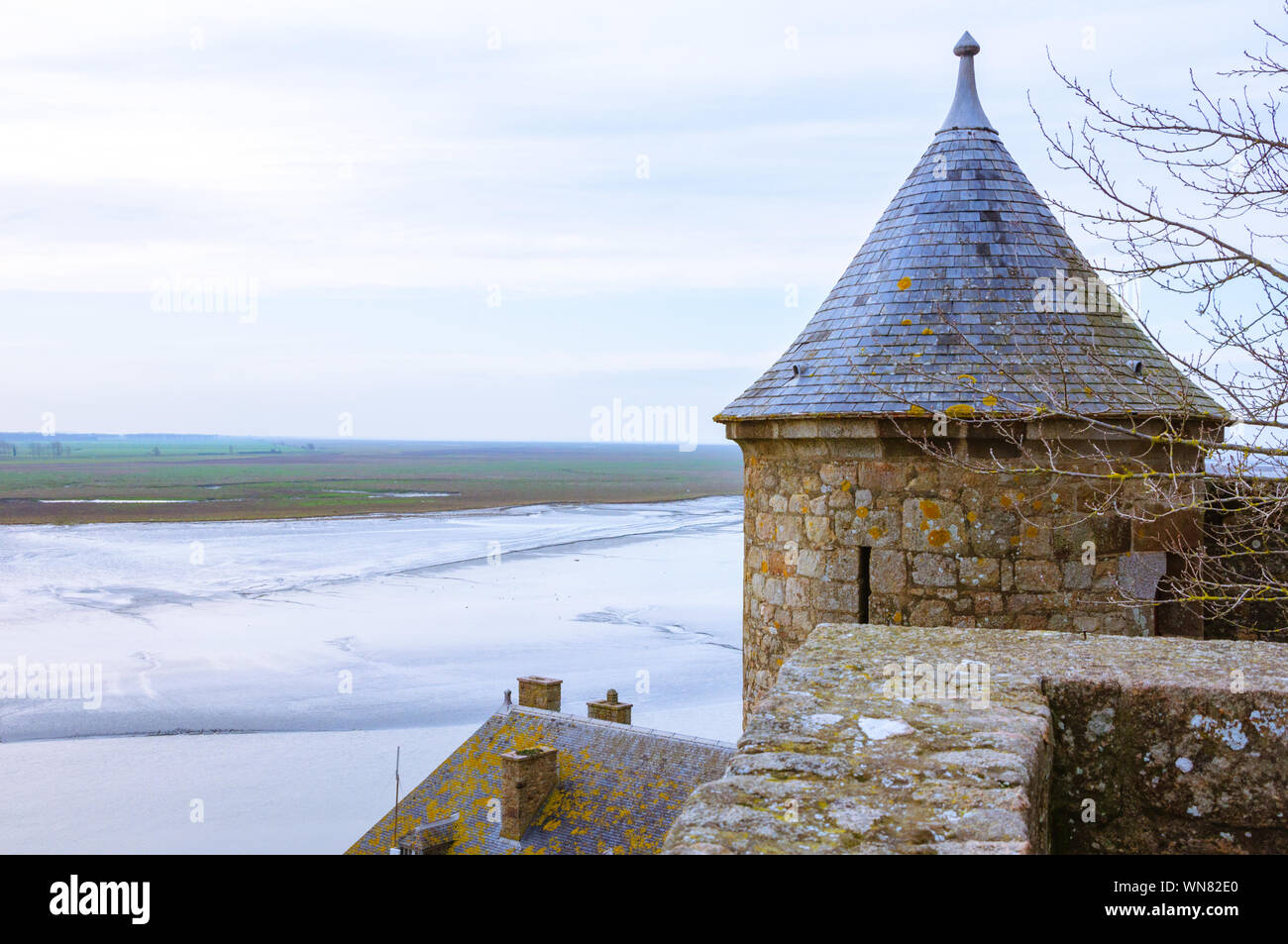 The fortress watchtower of Mont Saint Michel Castle overlooking the sea ...