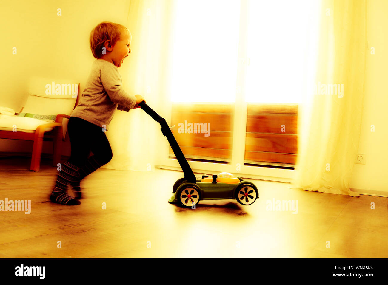 2 years old boy screaming and running across the room while playing ...