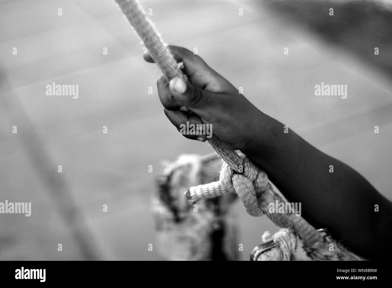 Boy holding rope hi-res stock photography and images - Alamy