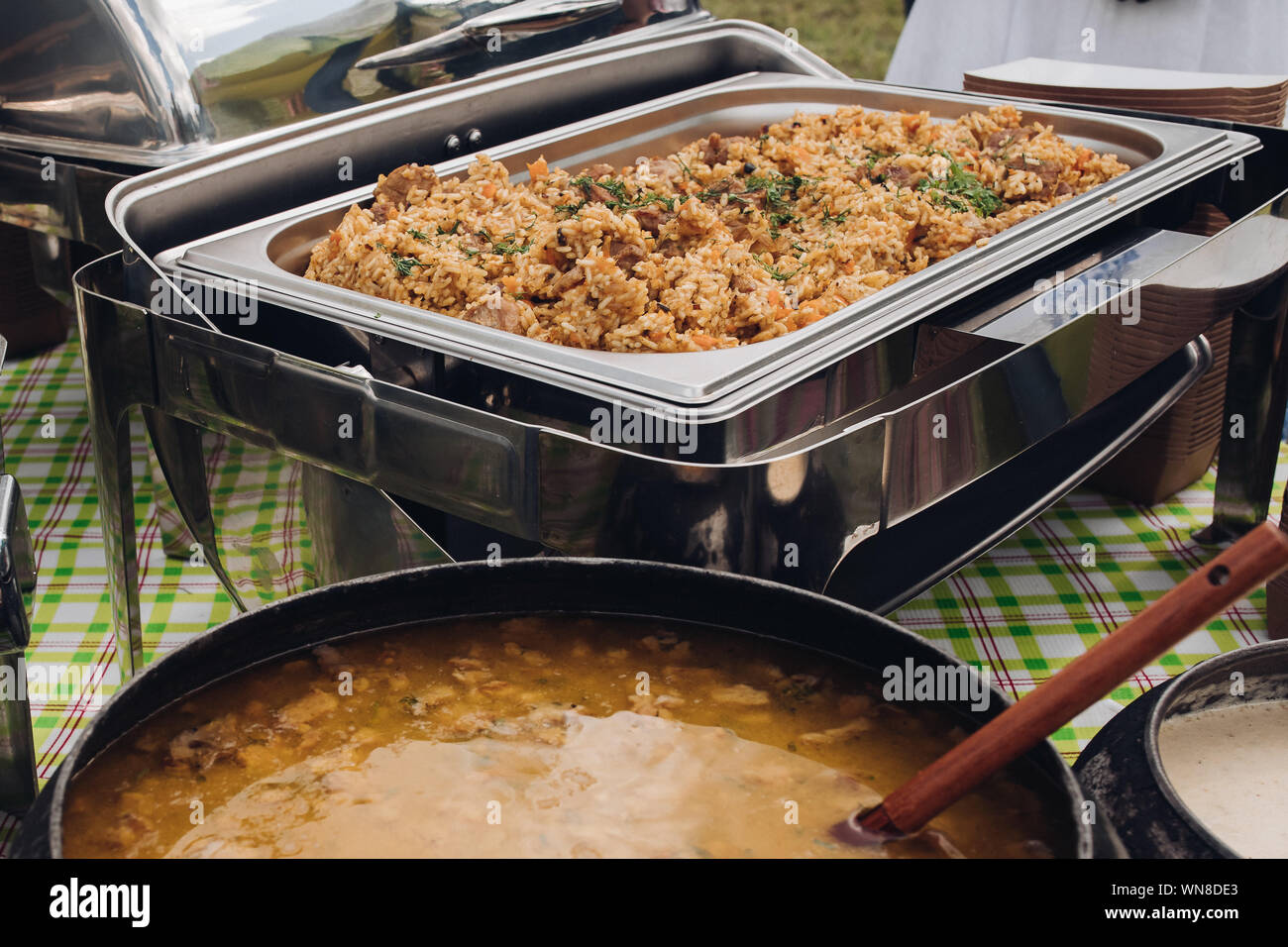 Close-up appetizing pilaf with gravy chicken beef serving for buffet ...
