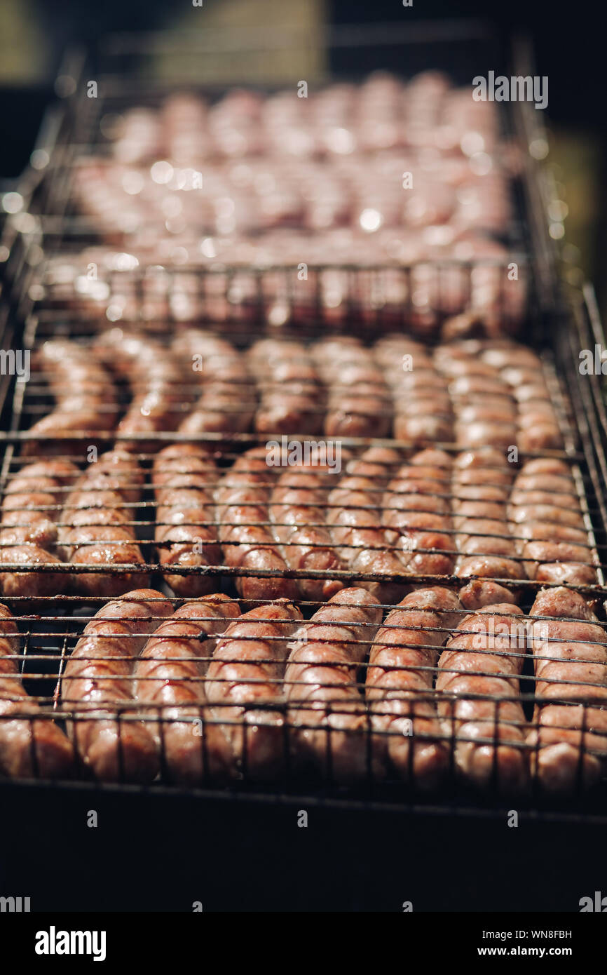 Sausages on grill at bbq party.Close-up of delicious chicken or pork ...