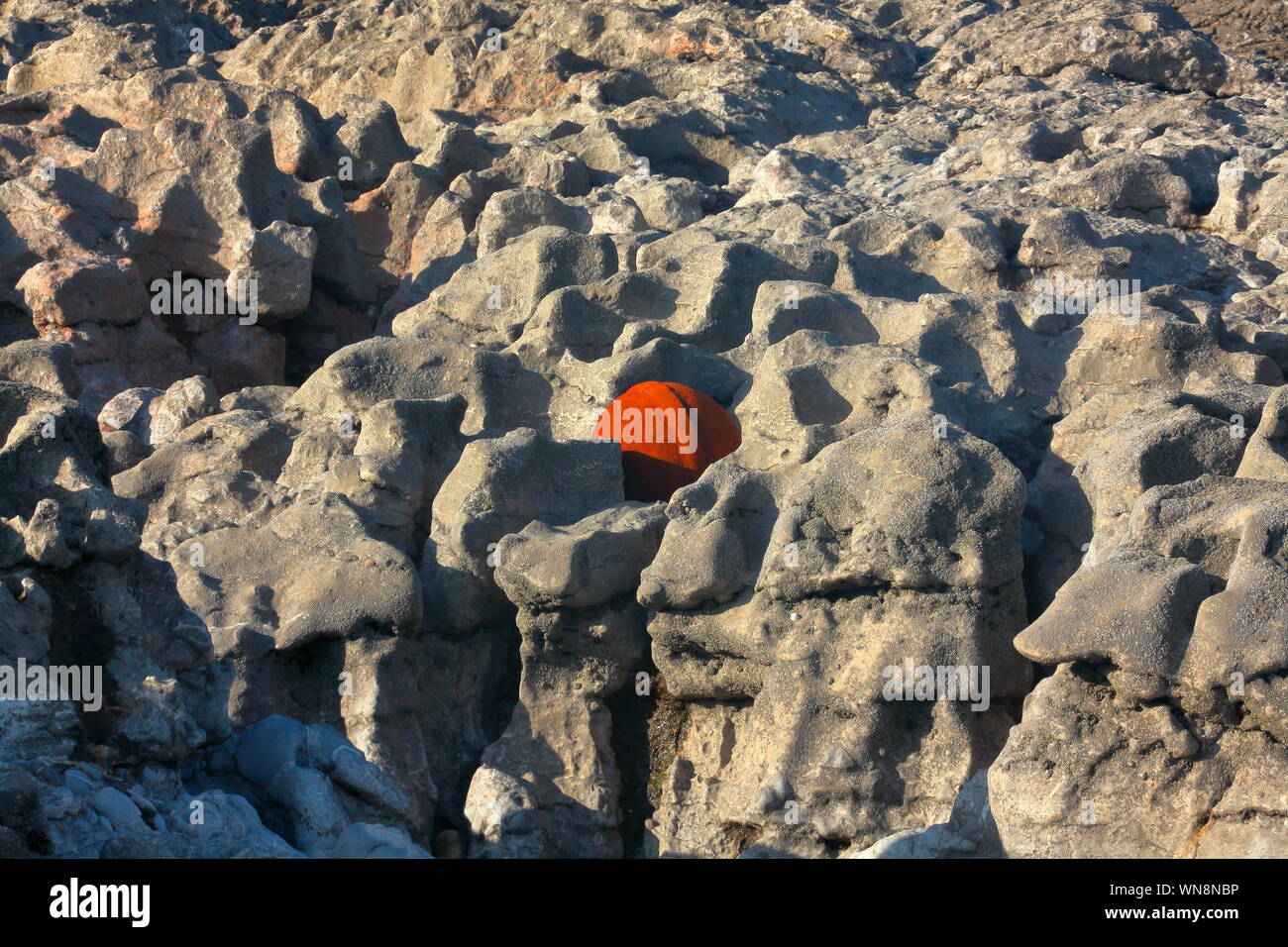A washed ashore hollow steel buoy or fishing net float made from steel ...