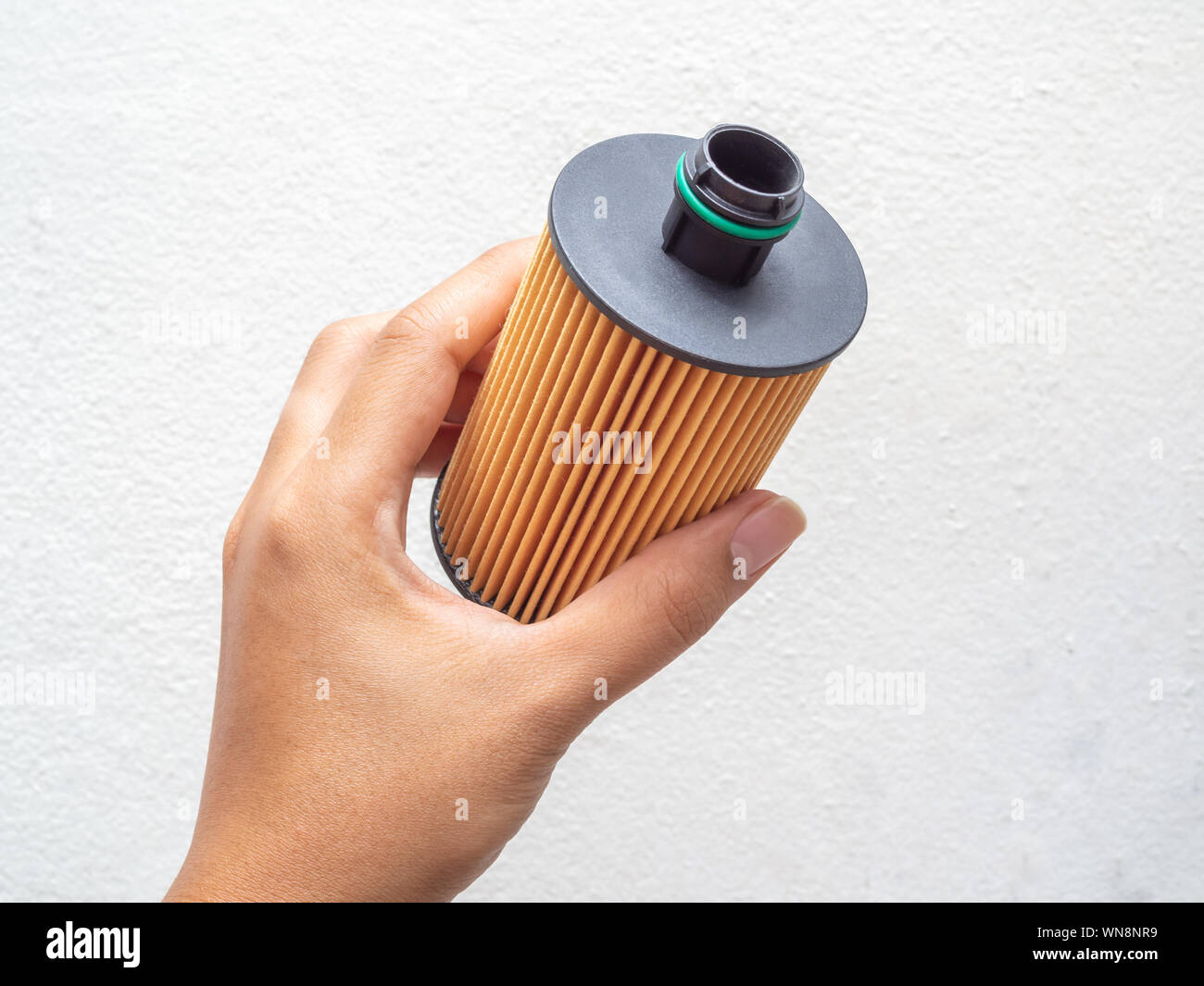 Oil filter. Hand holding car fuel filter isolated on white background ...