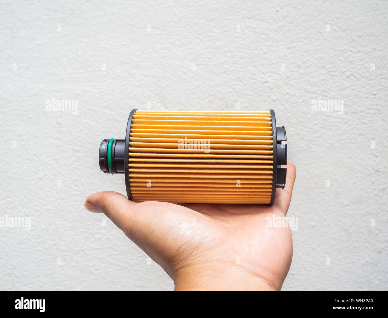 Oil filter. Hand holding car fuel filter isolated on white background ...