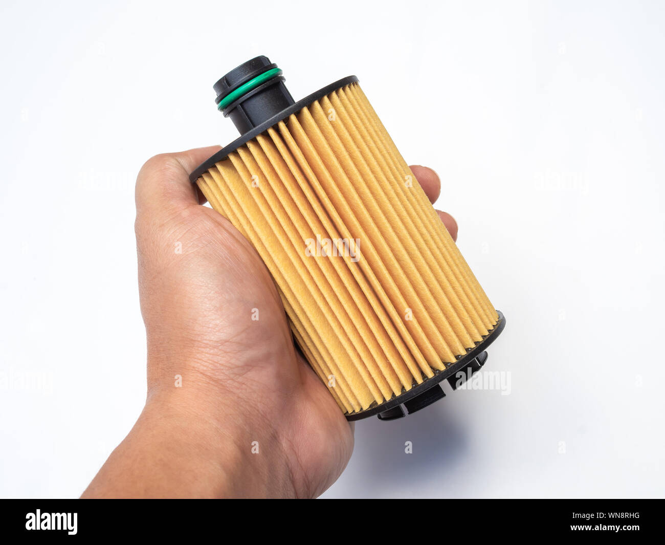 Oil filter. Hand holding car fuel filter isolated on white background ...
