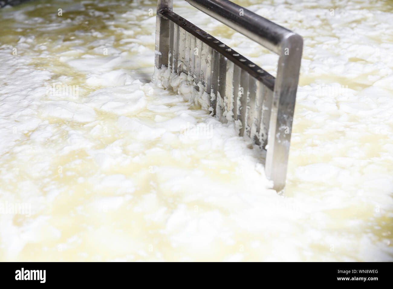 Hot milk mixing in the stainless tank during the fermentation process ...