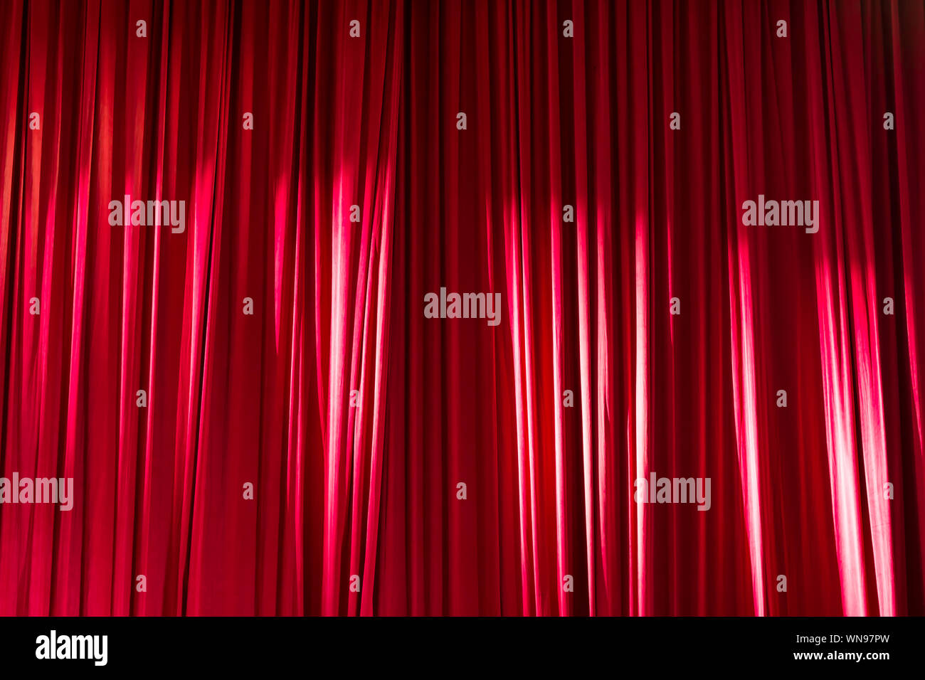 Red curtains and the spotlight in the Theater between shows Stock Photo ...