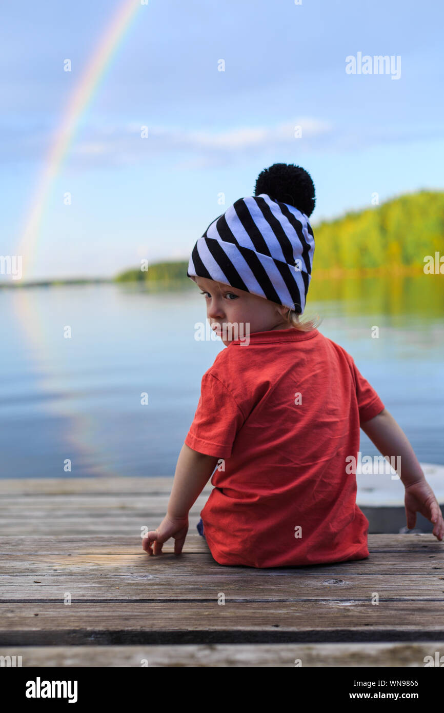 Children sitting on pier hi-res stock photography and images - Alamy