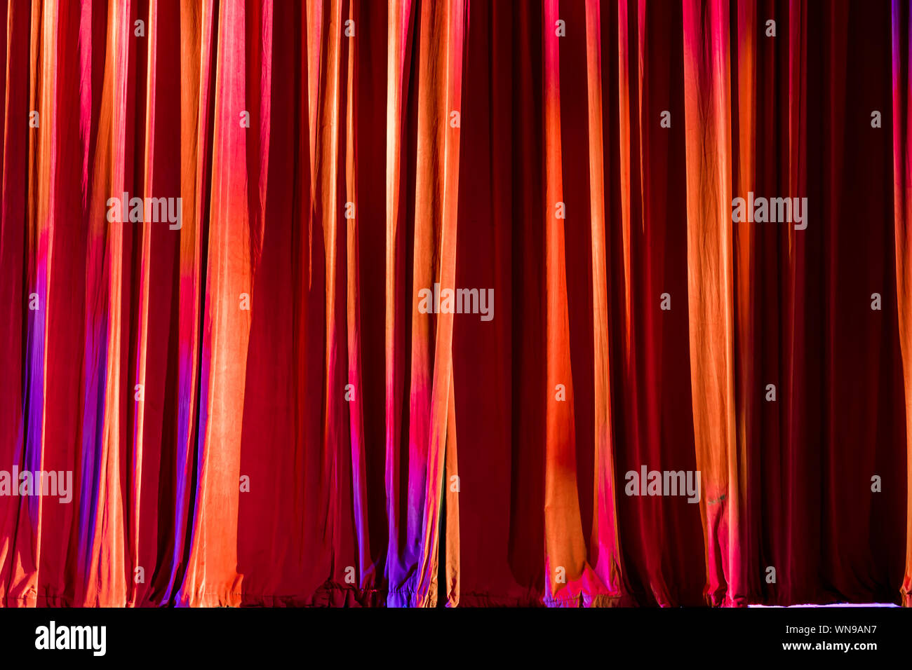 Red curtains and the spotlight in the Theater between shows Stock Photo ...