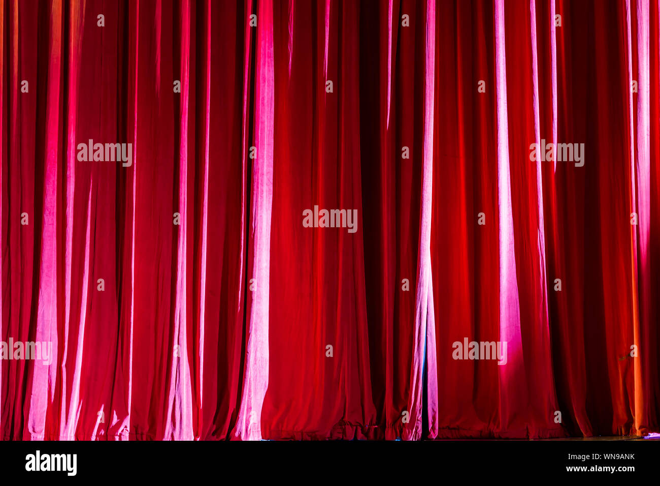 Red curtains and the spotlight in the Theater between shows Stock Photo ...