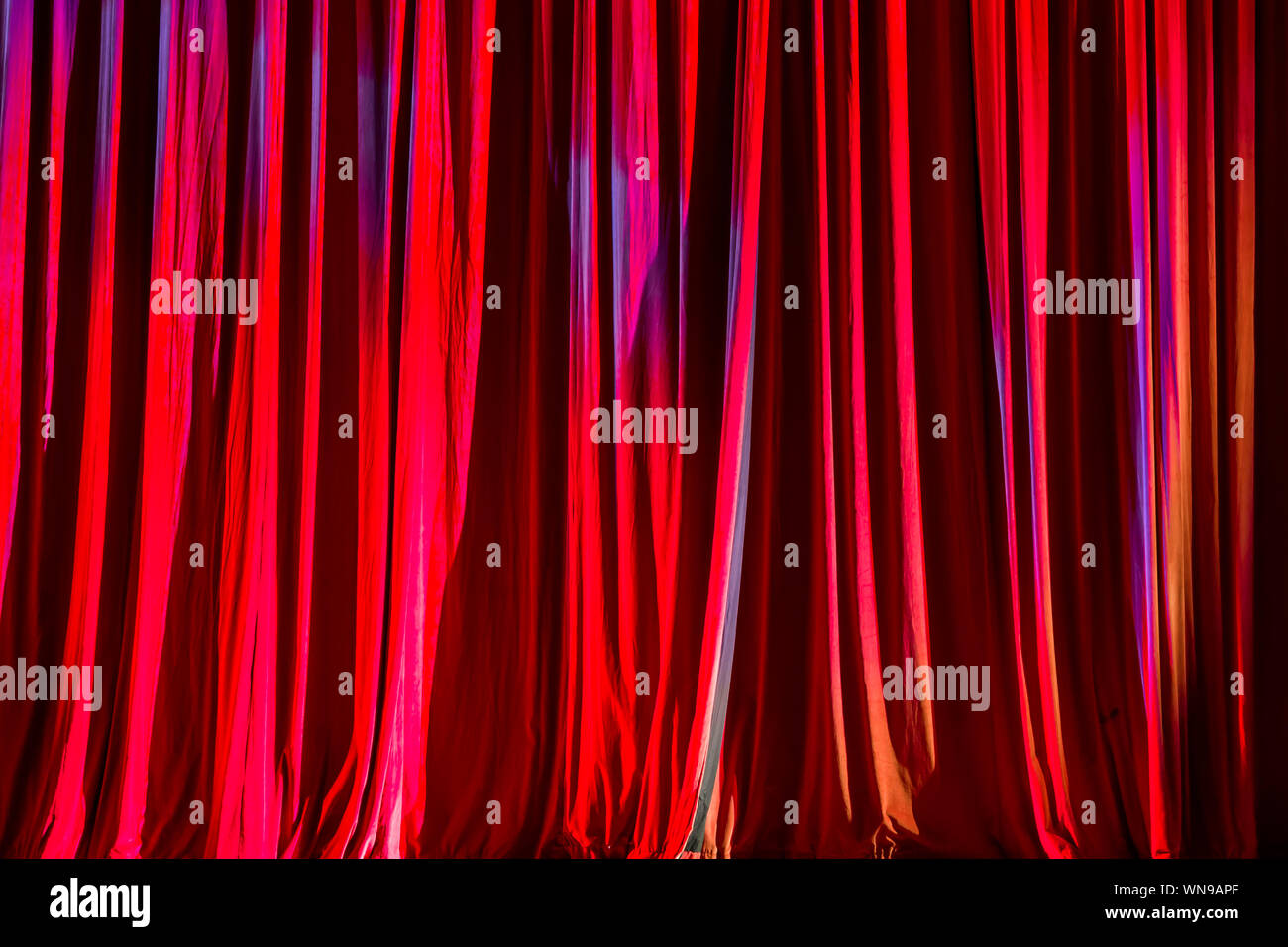 Red curtains and the spotlight in the Theater between shows Stock Photo ...