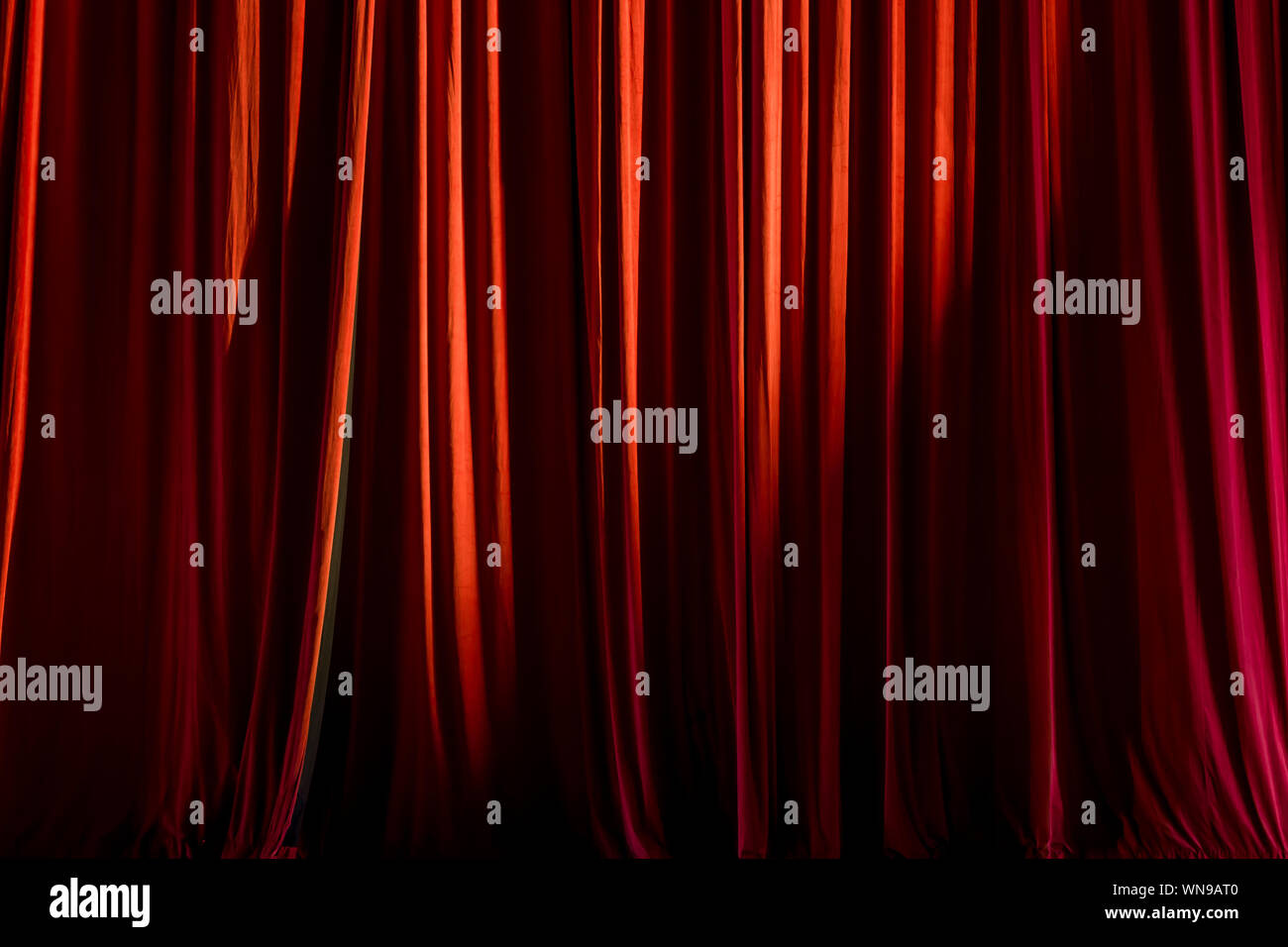 Red curtains and the spotlight in the Theater between shows Stock Photo ...