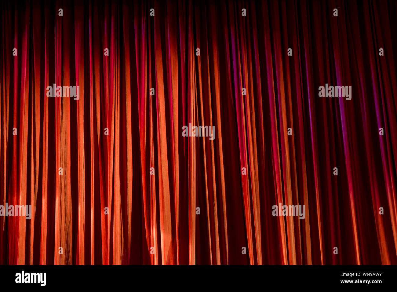 Red curtains and the spotlight in the Theater between shows Stock Photo ...