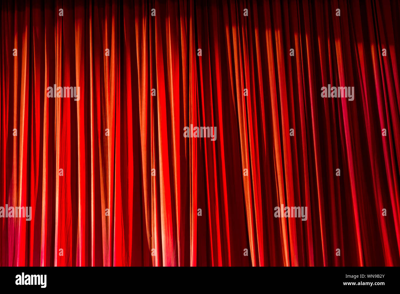 Red curtains and the spotlight in the Theater between shows Stock Photo ...