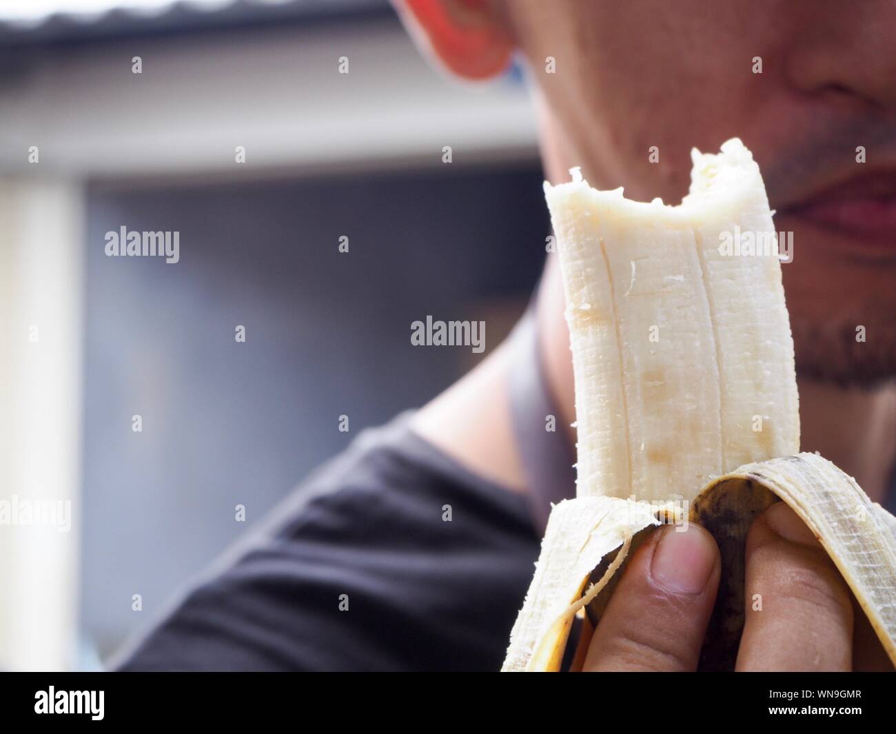 Close up man eating banana hi-res stock photography and images - Alamy