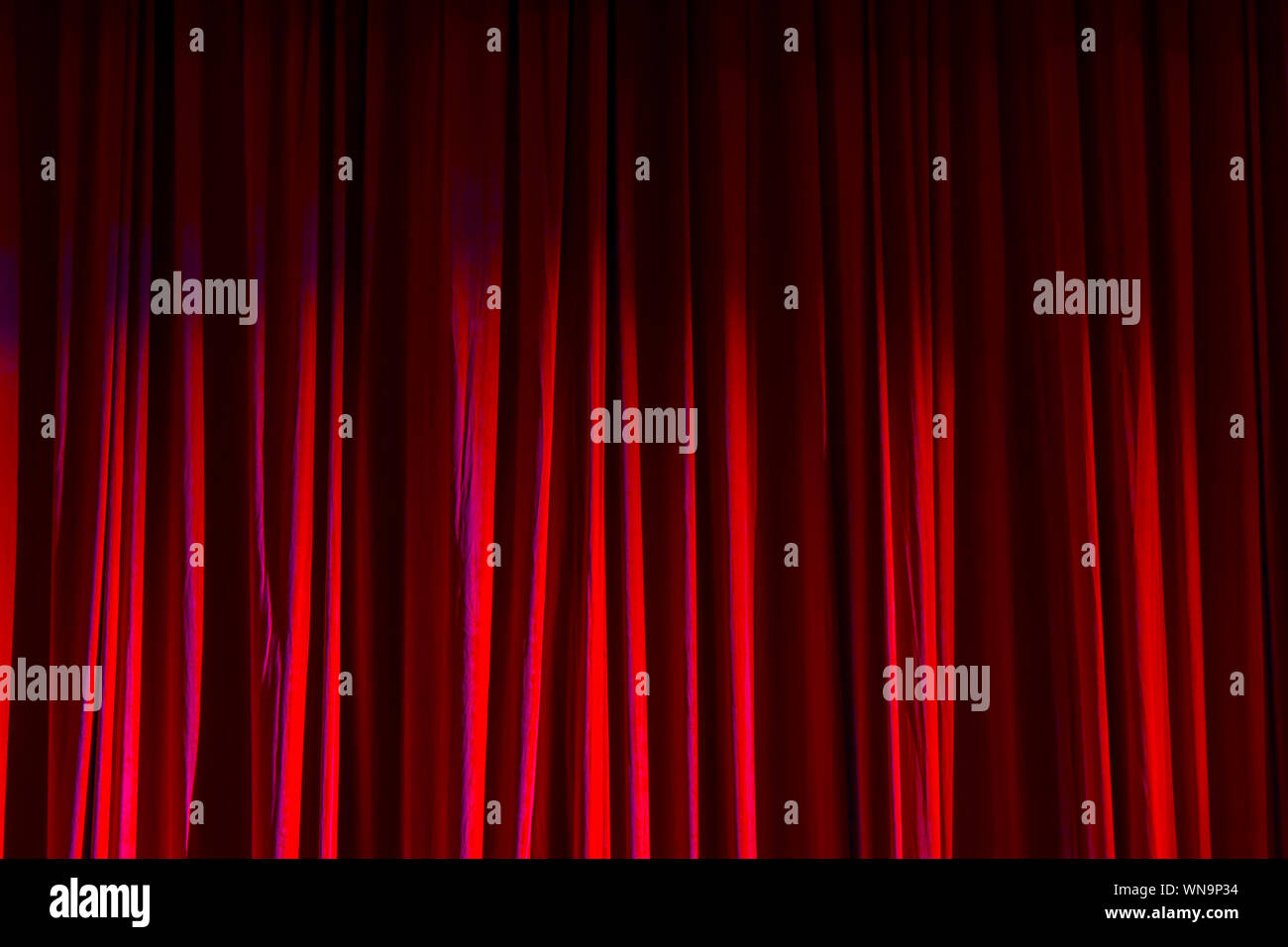 Red curtains and the spotlight in the Theater between shows Stock Photo ...