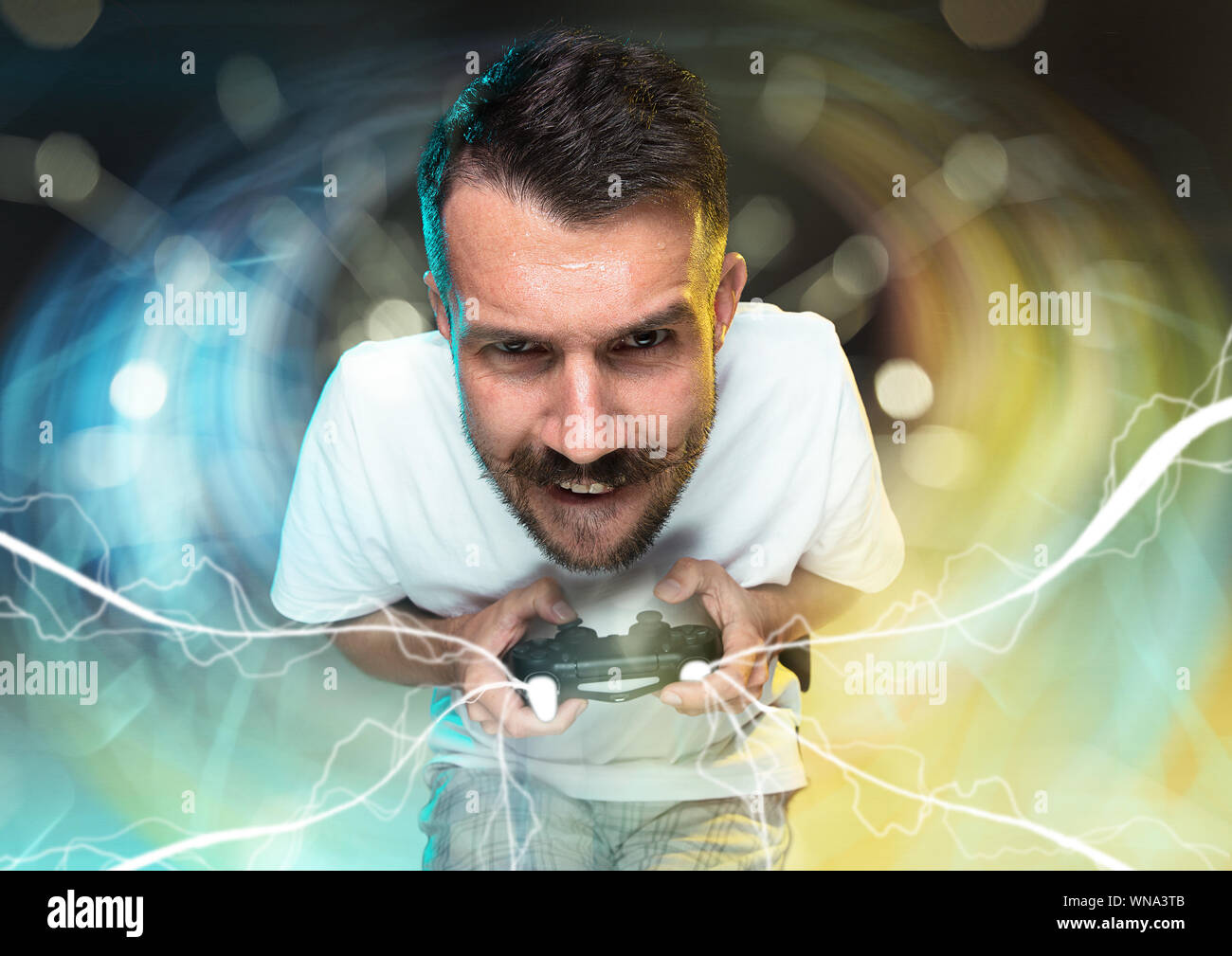 Enthusiastic gamer. Joyful young man holding a video game controller ...