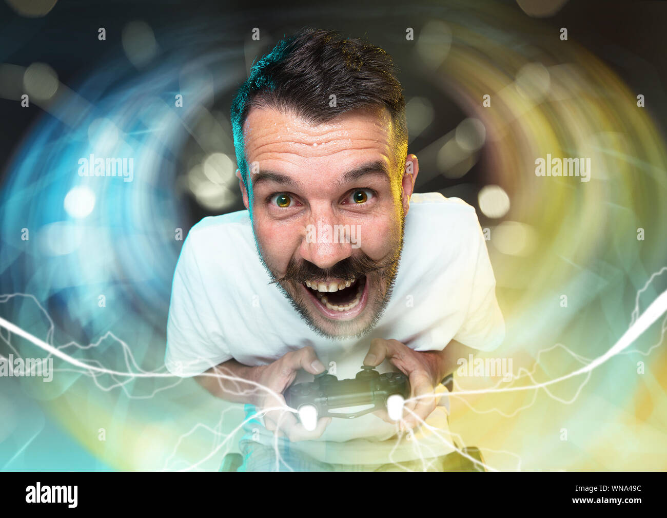 Enthusiastic gamer. Joyful young man holding a video game controller ...
