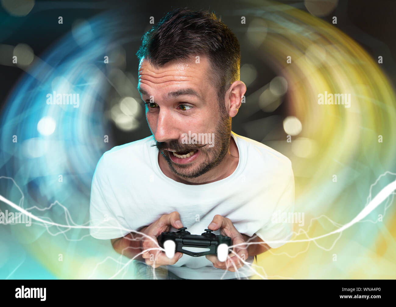 Enthusiastic gamer. Joyful young man holding a video game controller ...