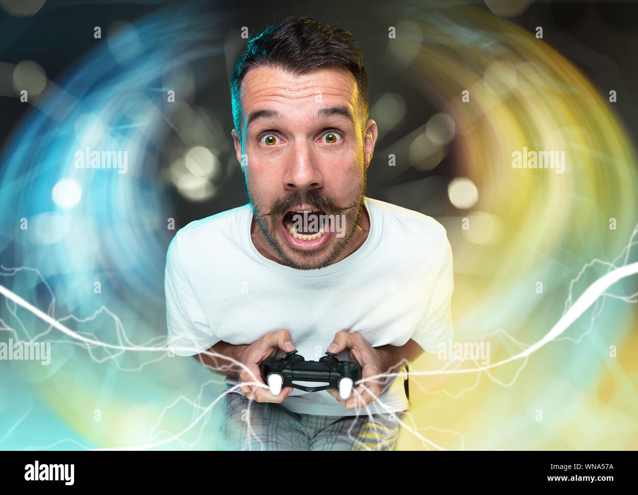 Enthusiastic gamer. Joyful young man holding a video game controller ...