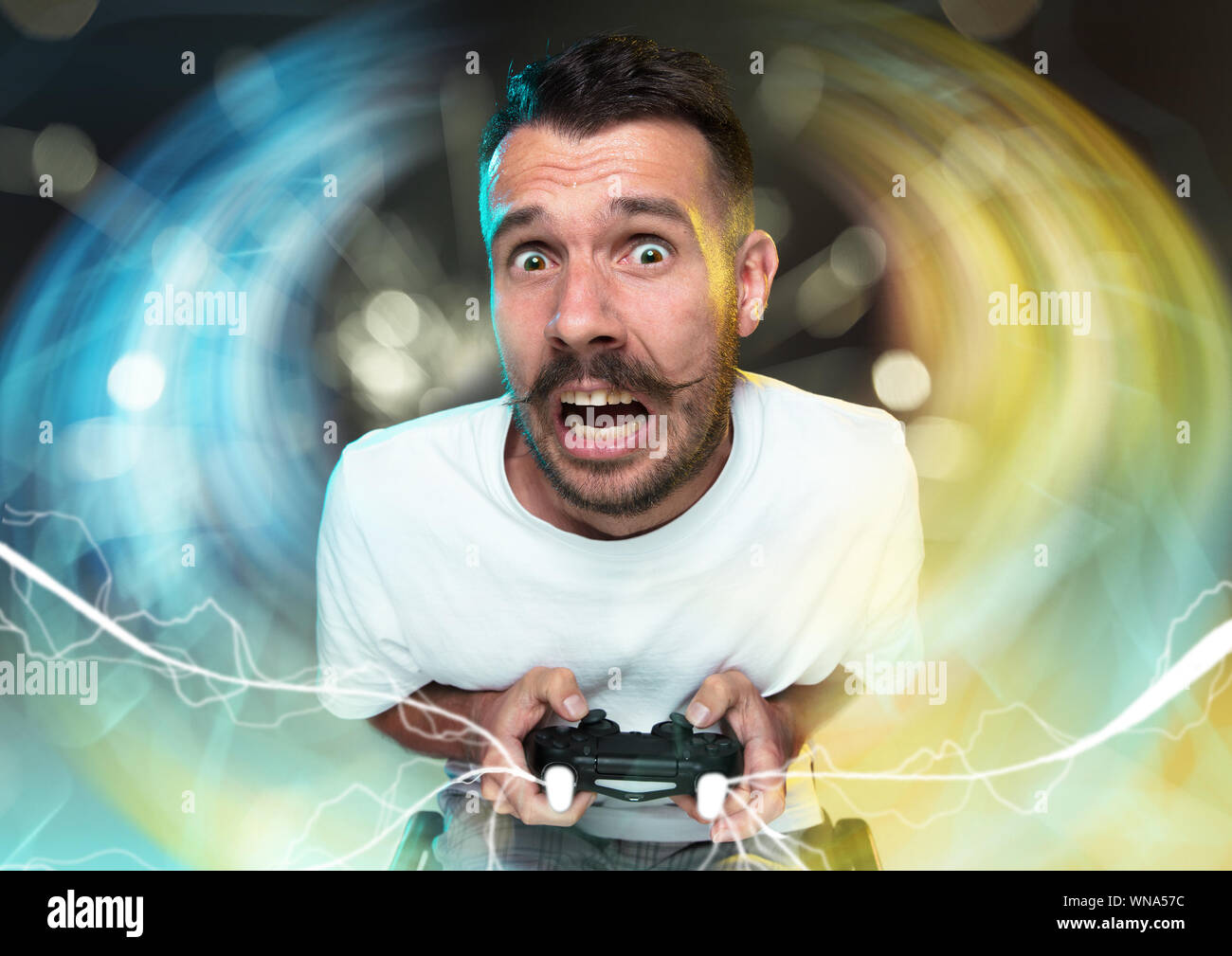 Enthusiastic gamer. Joyful young man holding a video game controller ...
