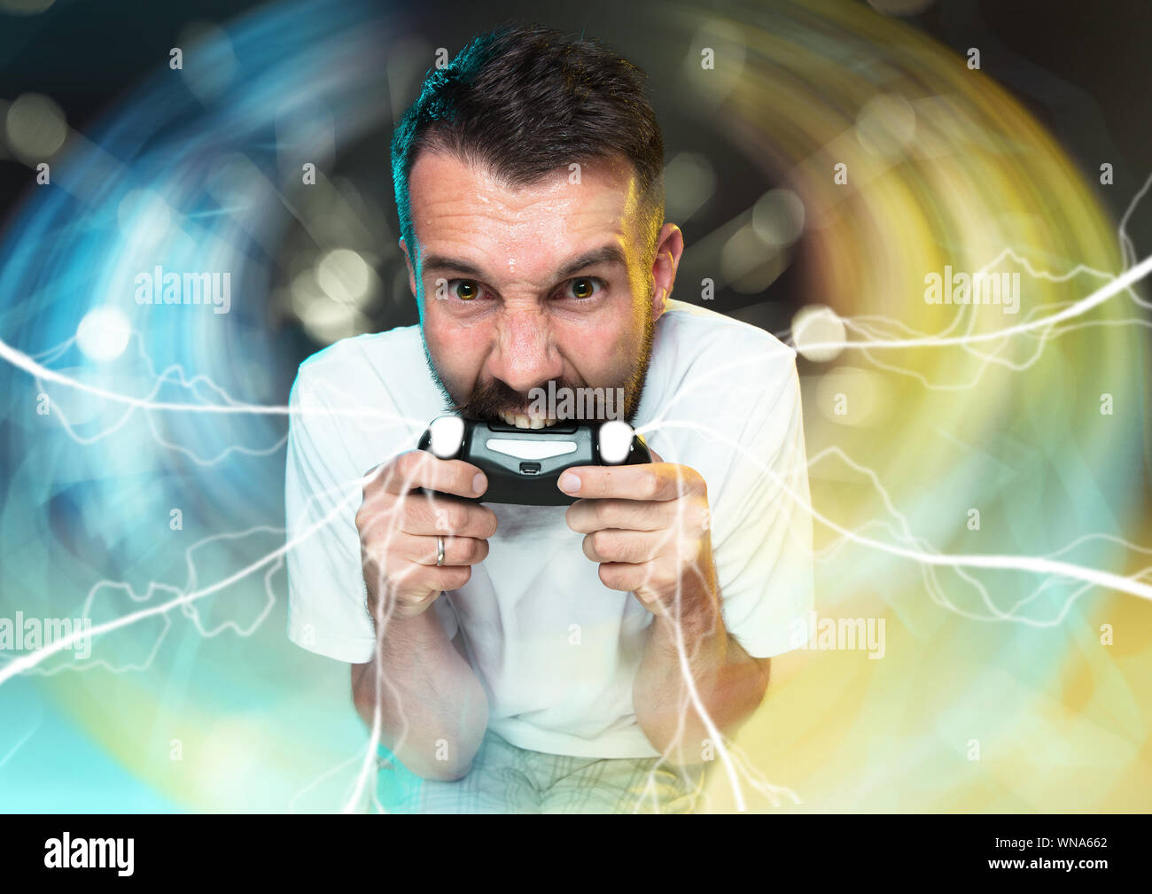Enthusiastic gamer. Joyful young man holding a video game controller ...