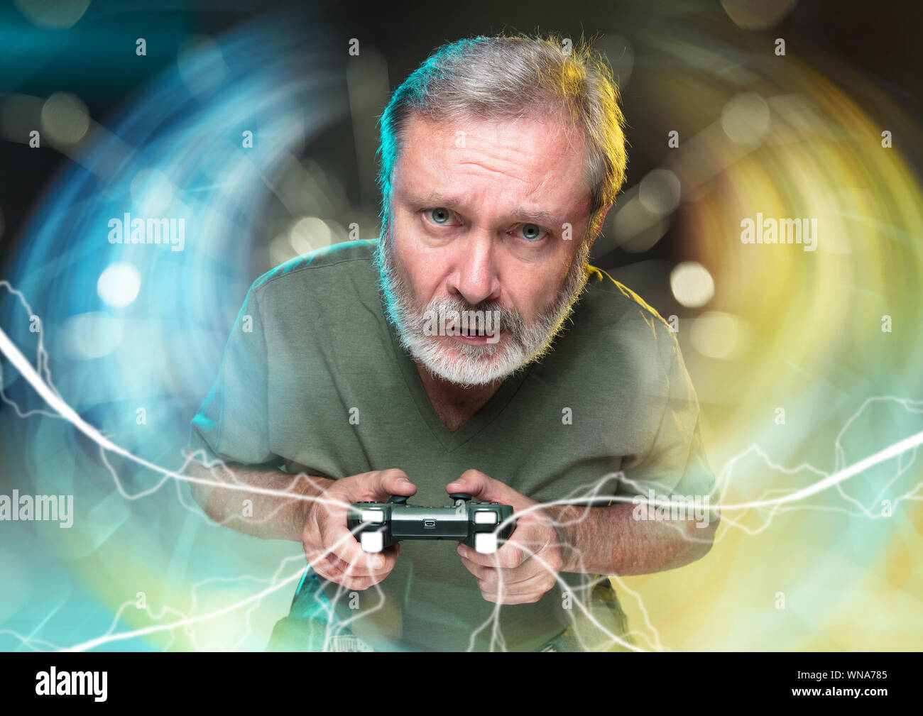 Breathtaking new life. Senior man holding a video game controller ...