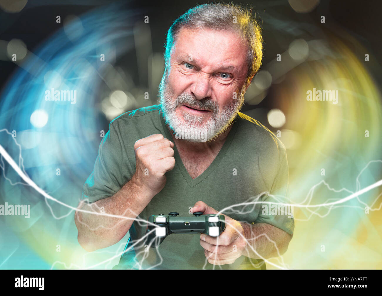 Breathtaking new life. Senior man holding a video game controller ...