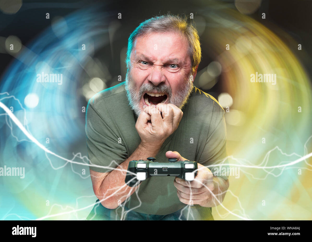 Breathtaking new life. Senior man holding a video game controller ...