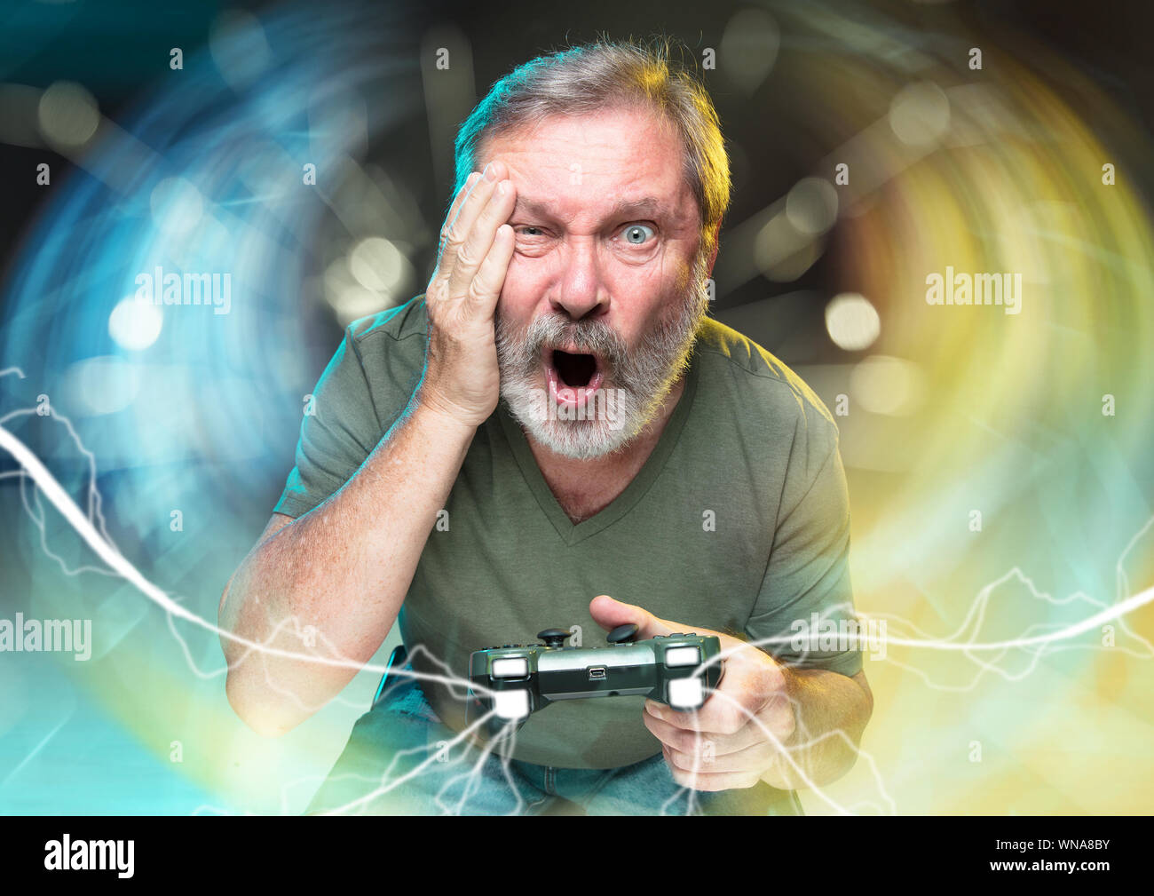 Breathtaking new life. Senior man holding a video game controller ...