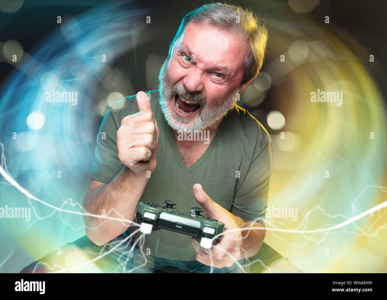 Breathtaking new life. Senior man holding a video game controller ...