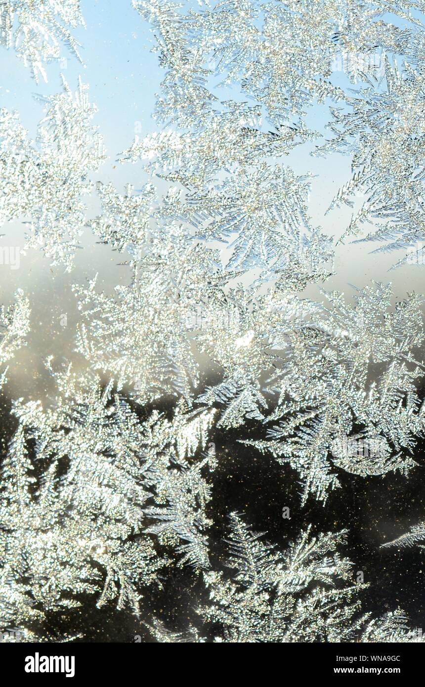 Snowflakes frost rime macro on window glass pane. Colorful ice on the ...