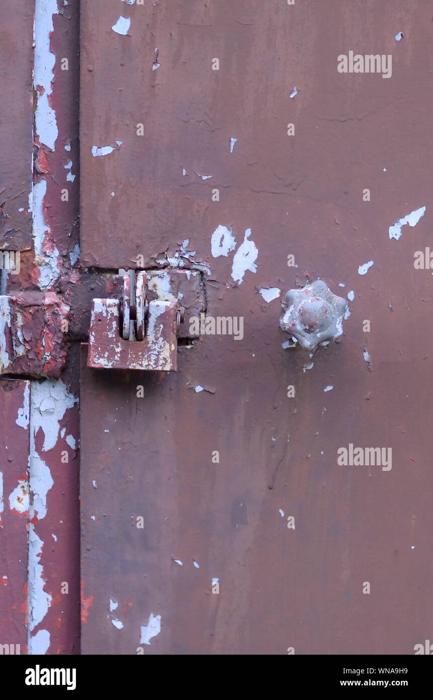 Closed metal lock garage door security protection padlock. Old brown ...