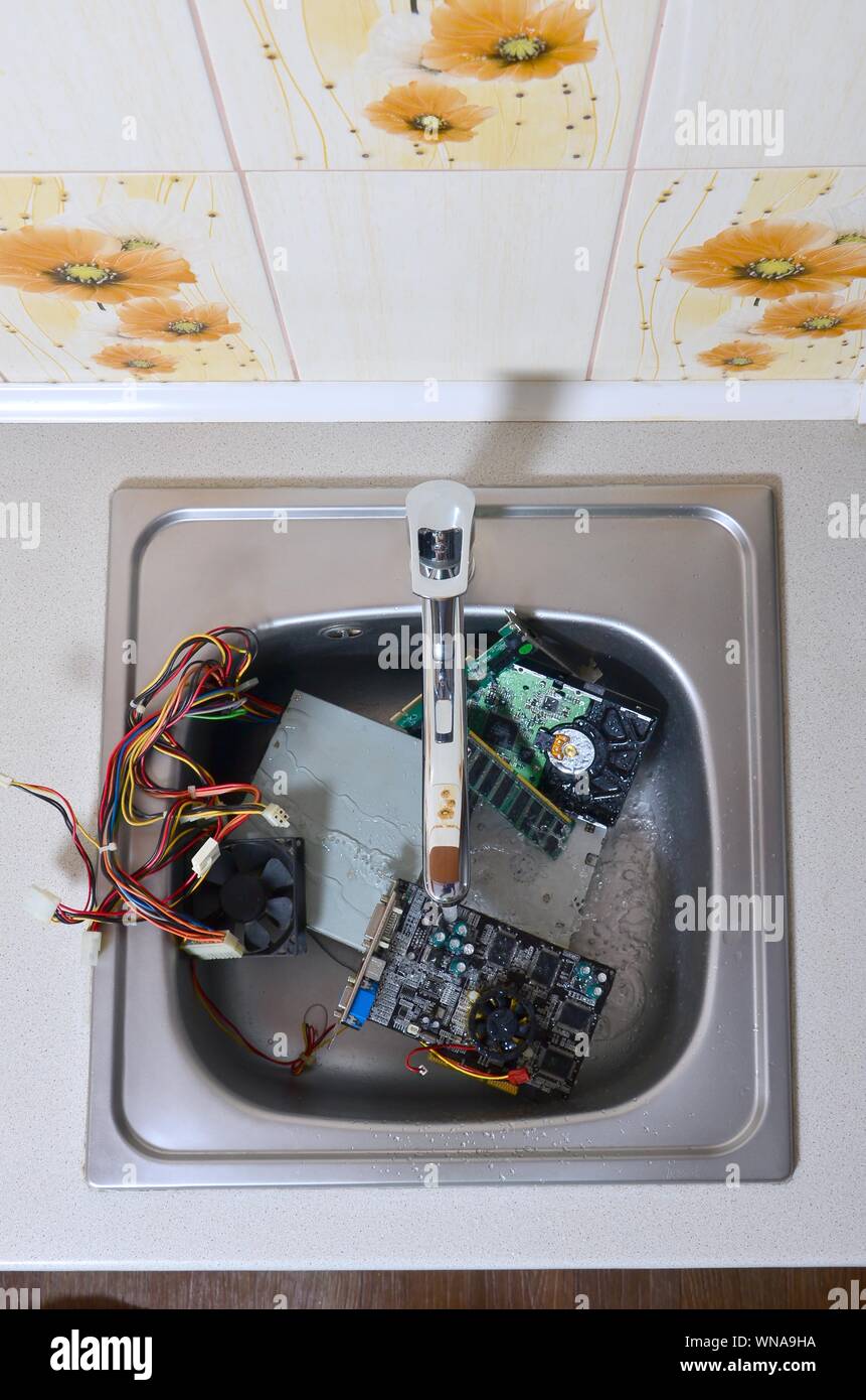 Personal computer cleaning metaphoric concept. Hardware in kitchen sink ...