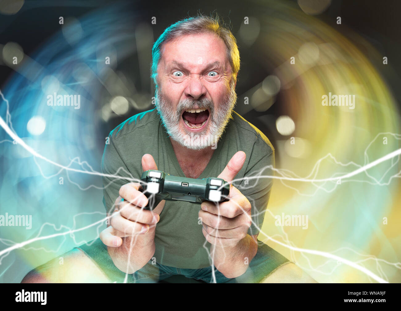 Breathtaking new life. Senior man holding a video game controller ...