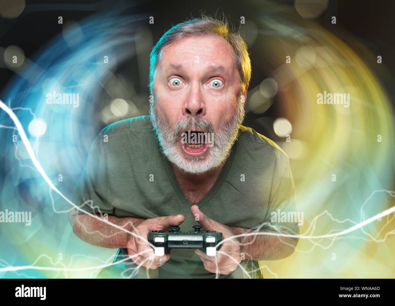 Breathtaking new life. Senior man holding a video game controller ...