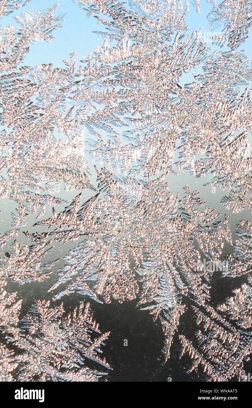 Snowflakes frost rime macro on window glass pane. Colorful ice on the ...