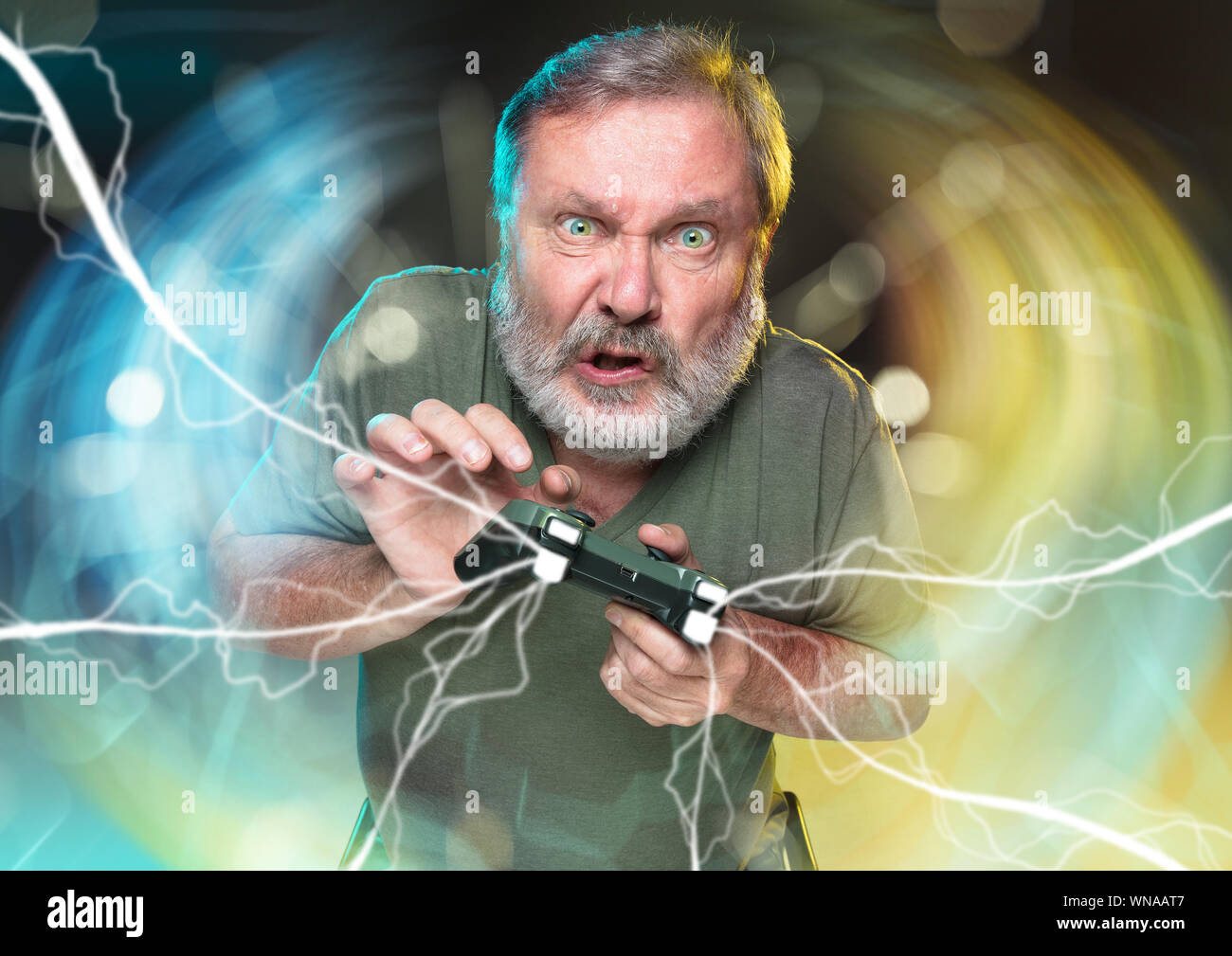 Breathtaking new life. Senior man holding a video game controller ...