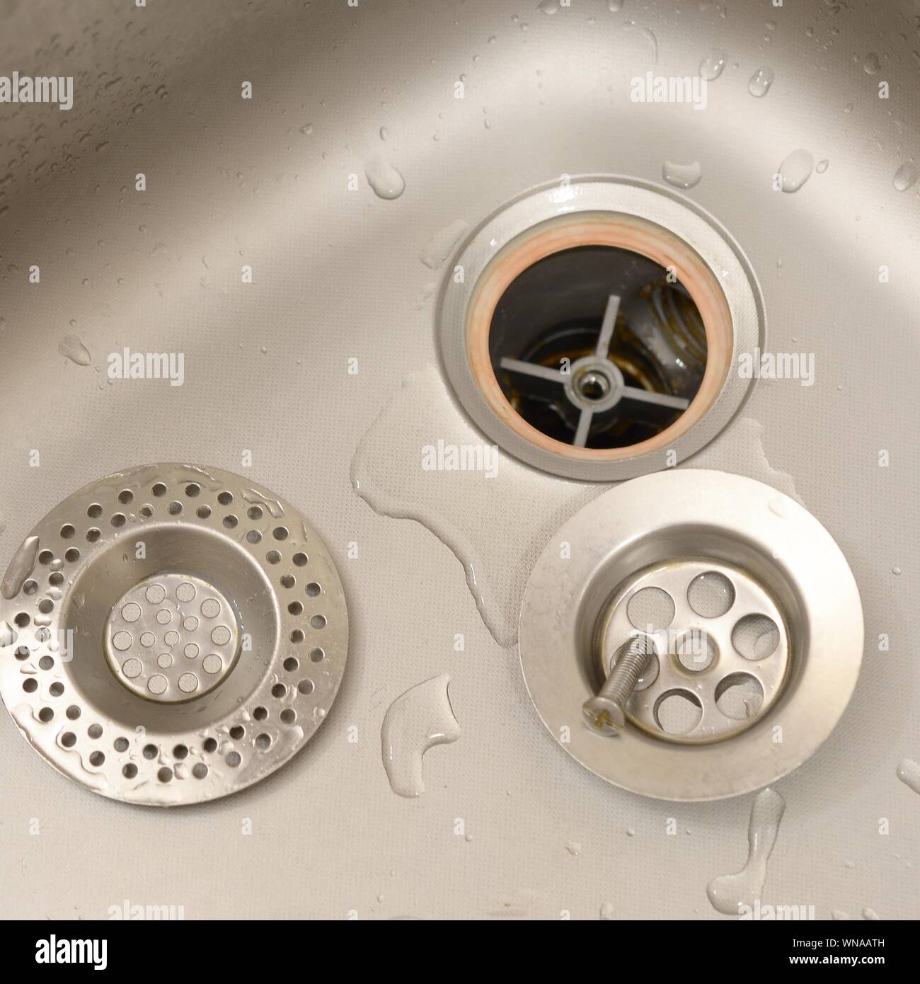 Silvery kitchen sink with a disassembled protective filter. Kitchen ...