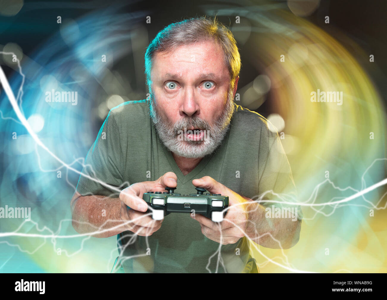 Breathtaking new life. Senior man holding a video game controller ...