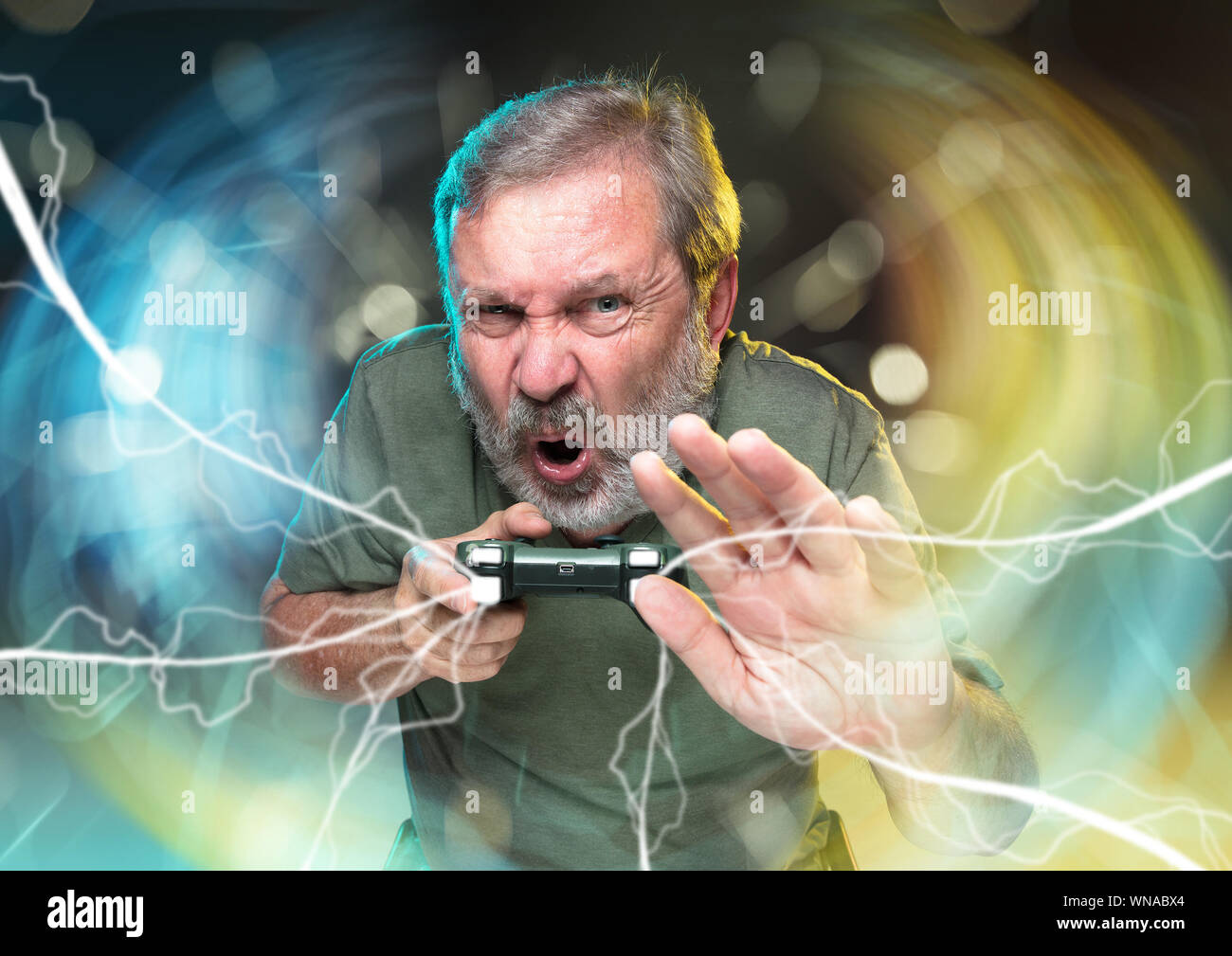 Breathtaking new life. Senior man holding a video game controller ...