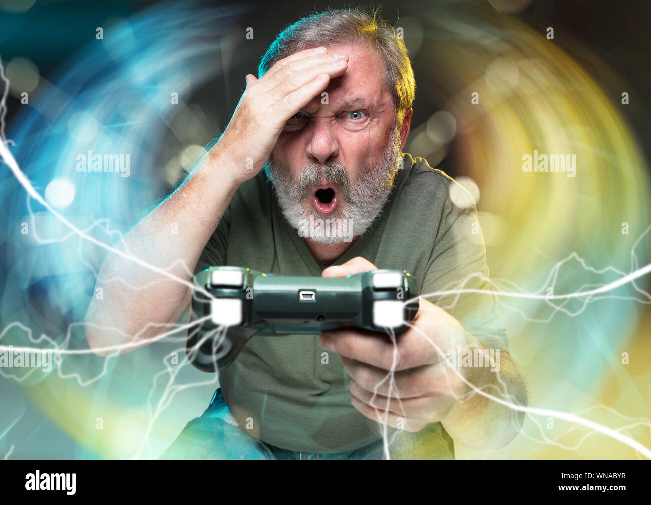 Breathtaking new life. Senior man holding a video game controller ...