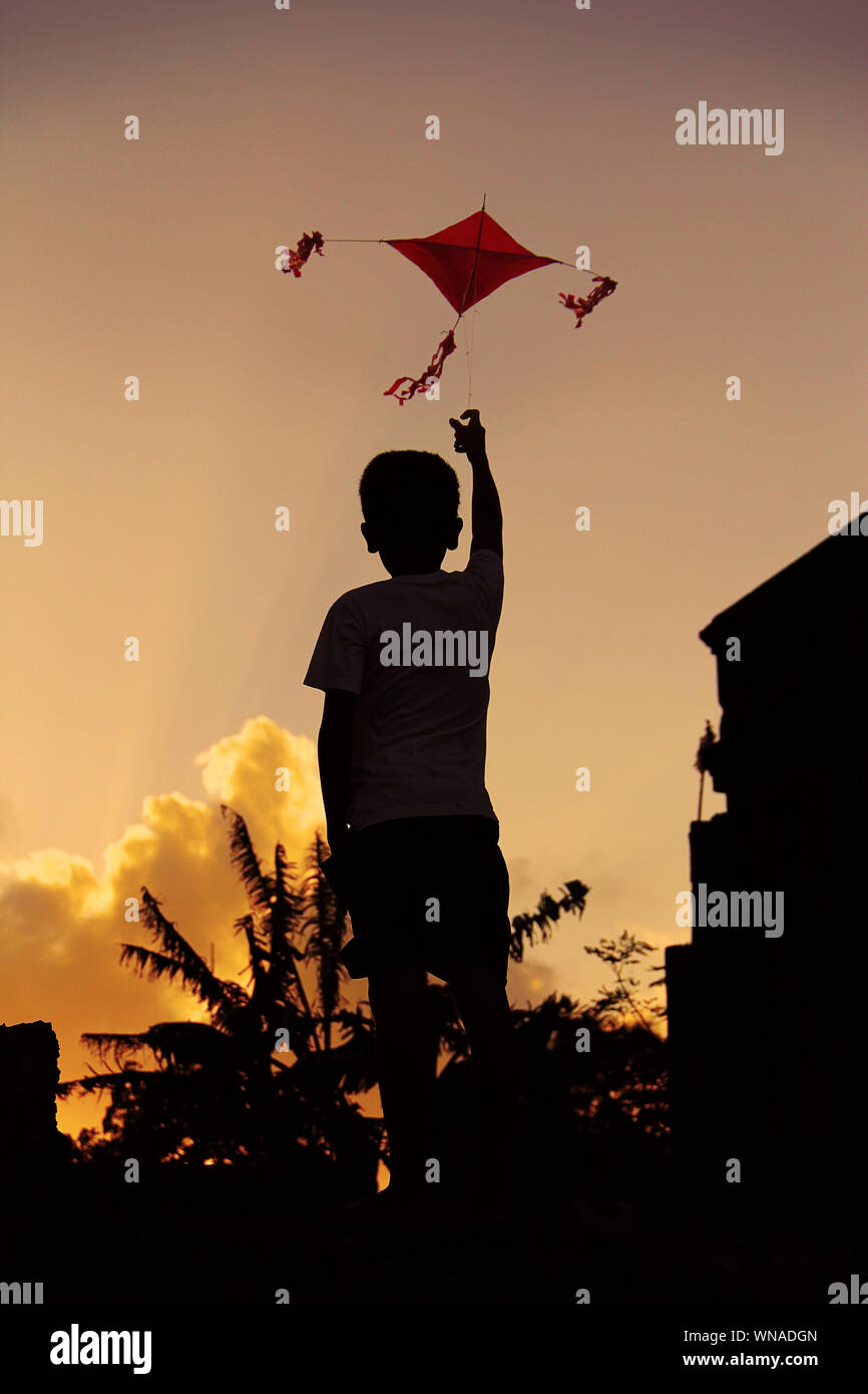 Silhouette Of Person Flying Kite High Resolution Stock Photography and ...