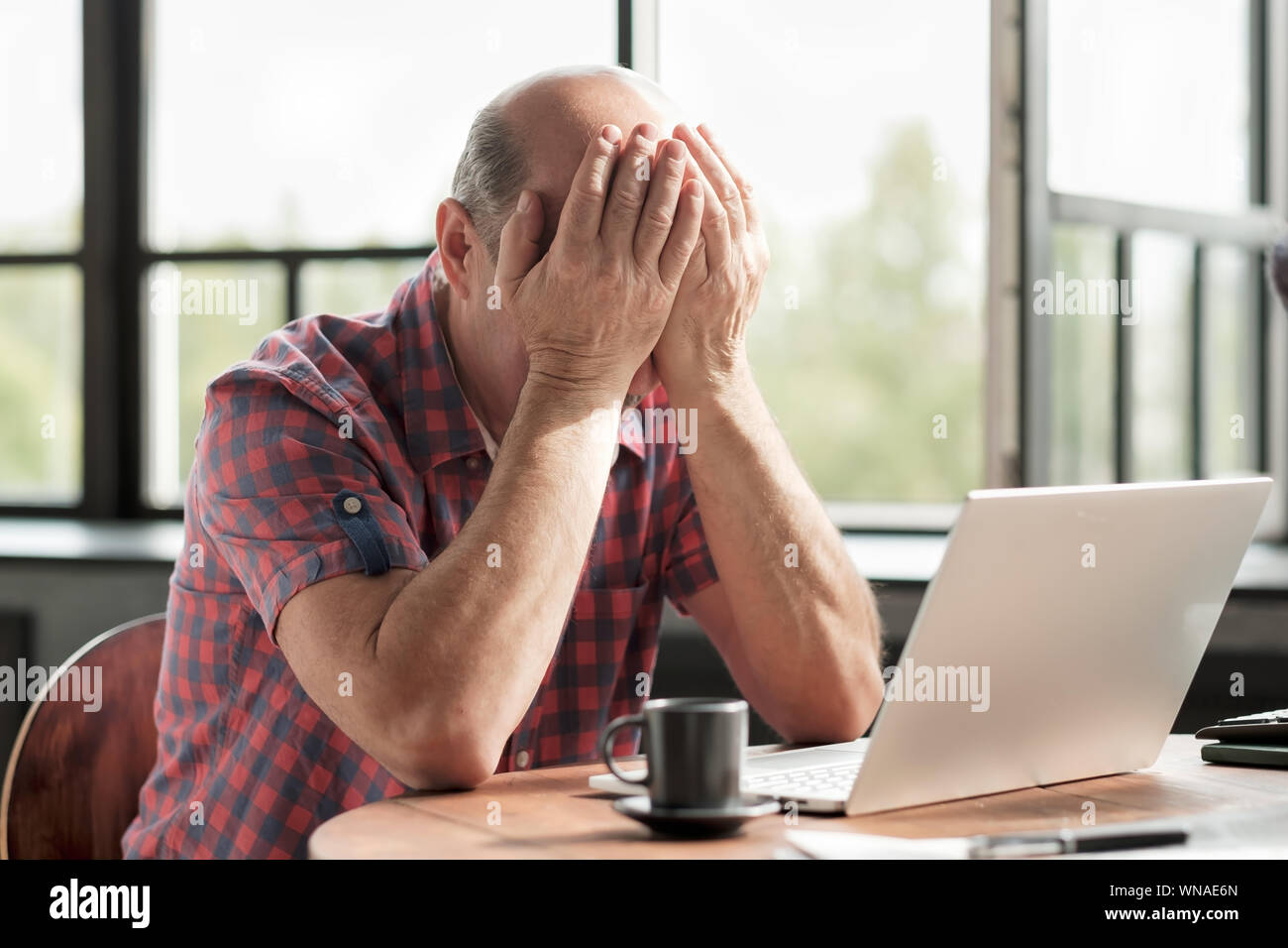Senior caucasian man rubbing his tired eyes. He is tired to look on ...