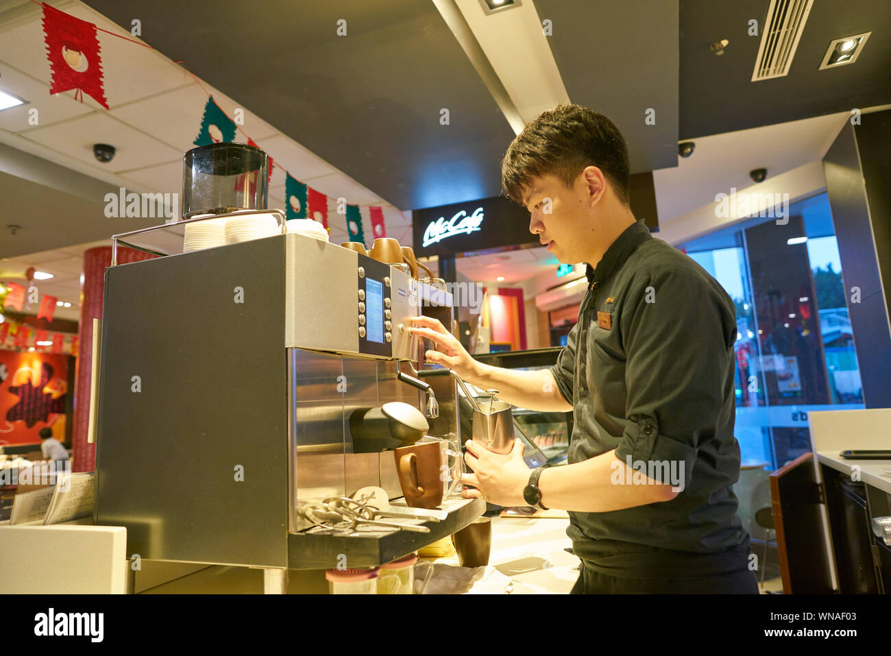 SHENZHEN, CHINA - CIRCA FEBRUARY, 2019: worker prepare coffee at McCafe ...